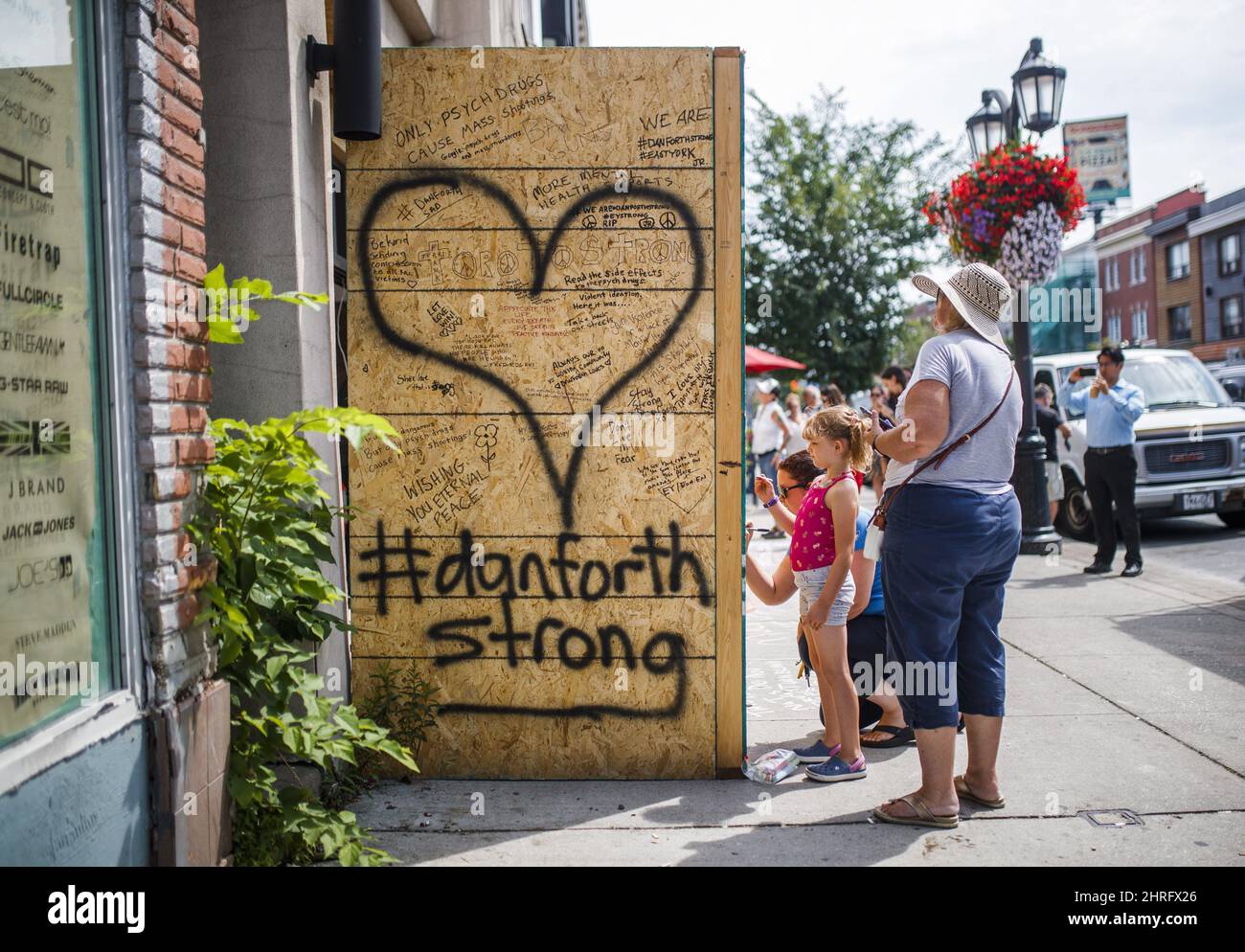 People write messages on a makeshift memorial remembering the victims ...