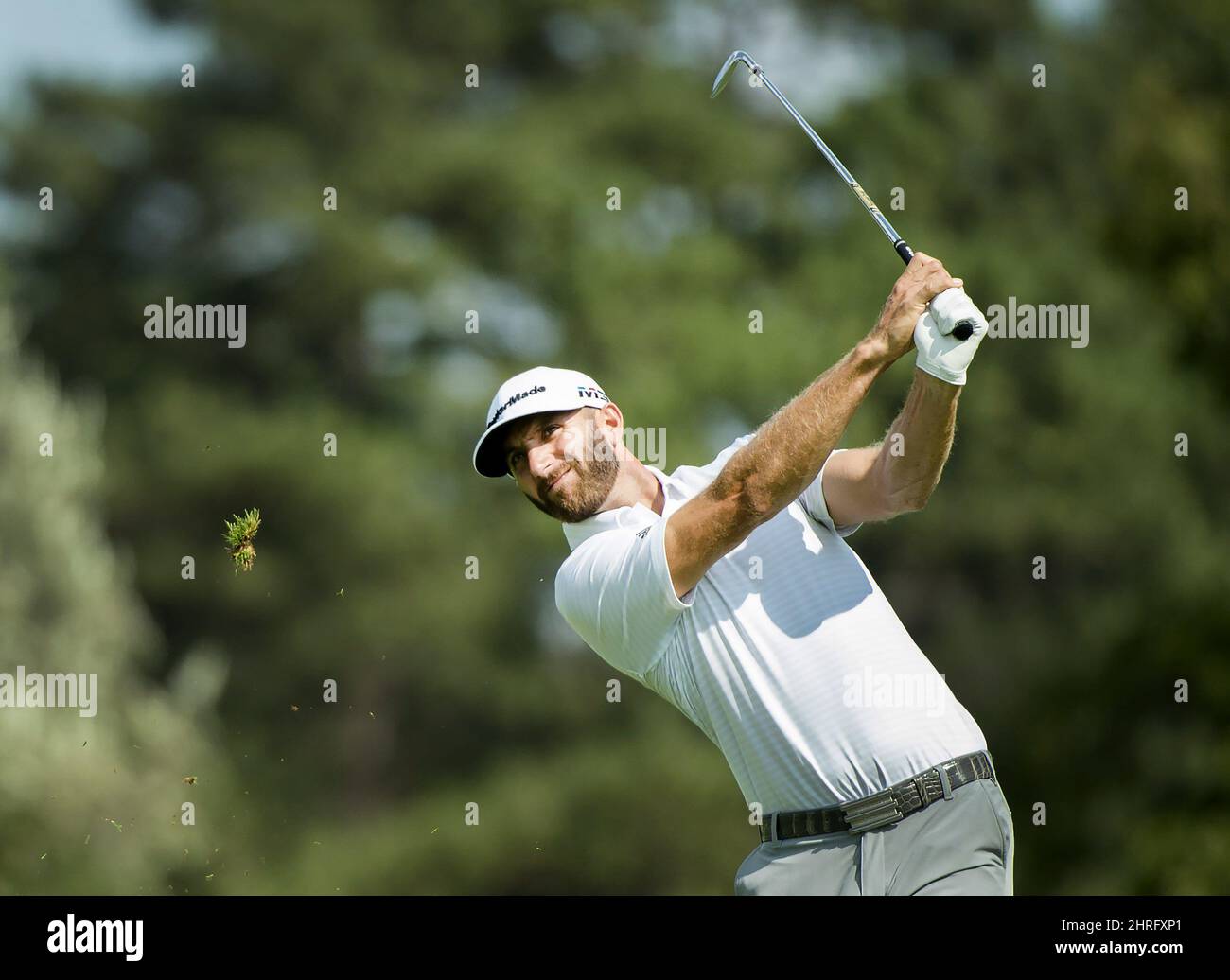 Dustin Johnson, of the United States, watches his approach shot on the ...