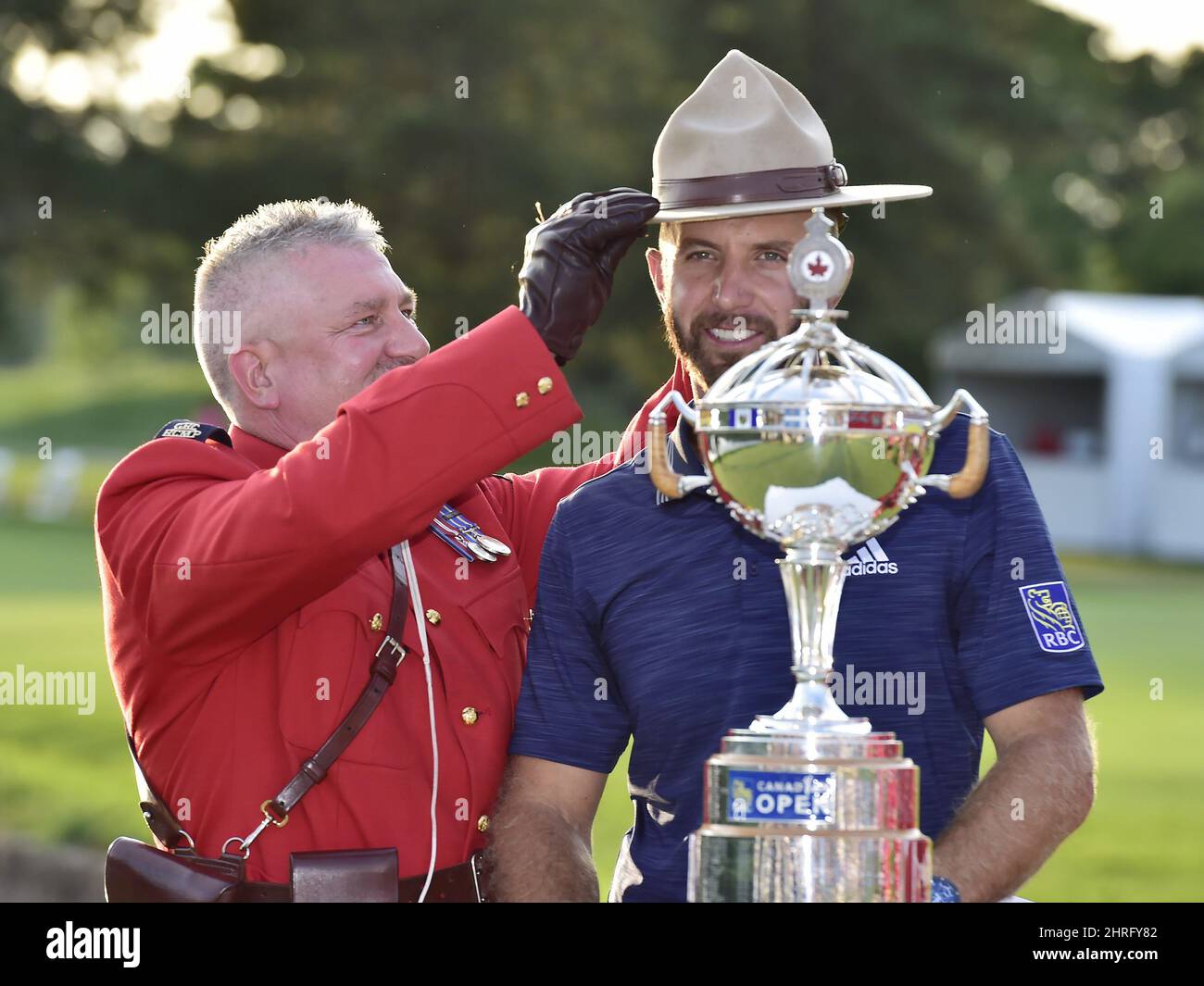 A Royal Canadian Mounted Police officer places a RCMP Stetson on Dustin ...