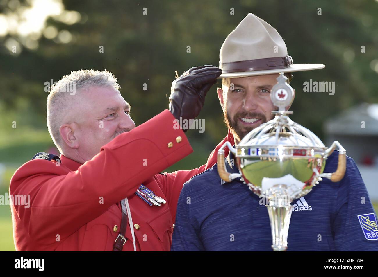 A Royal Canadian Mounted Police officer places a RCMP Stetson on Dustin ...