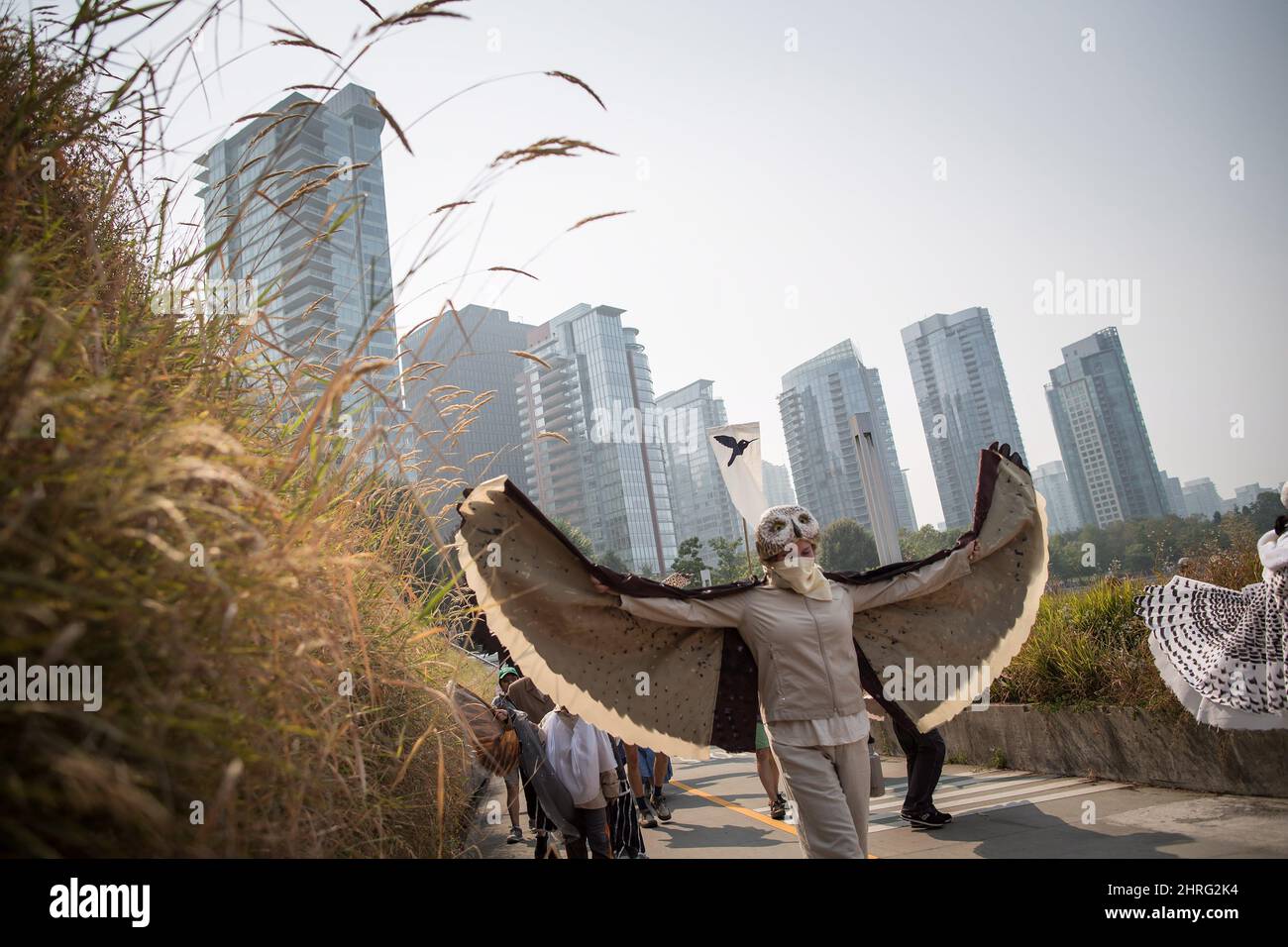 A woman dressed like an owl and others in lifelike avian costumes ...