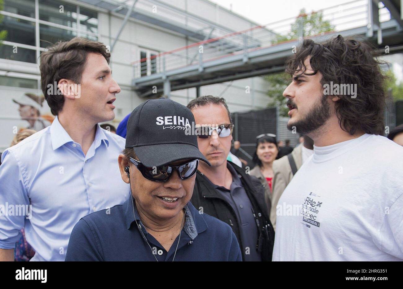 Prime Minister Justin Trudeau, left, is confronted by Matthieu Brien ...