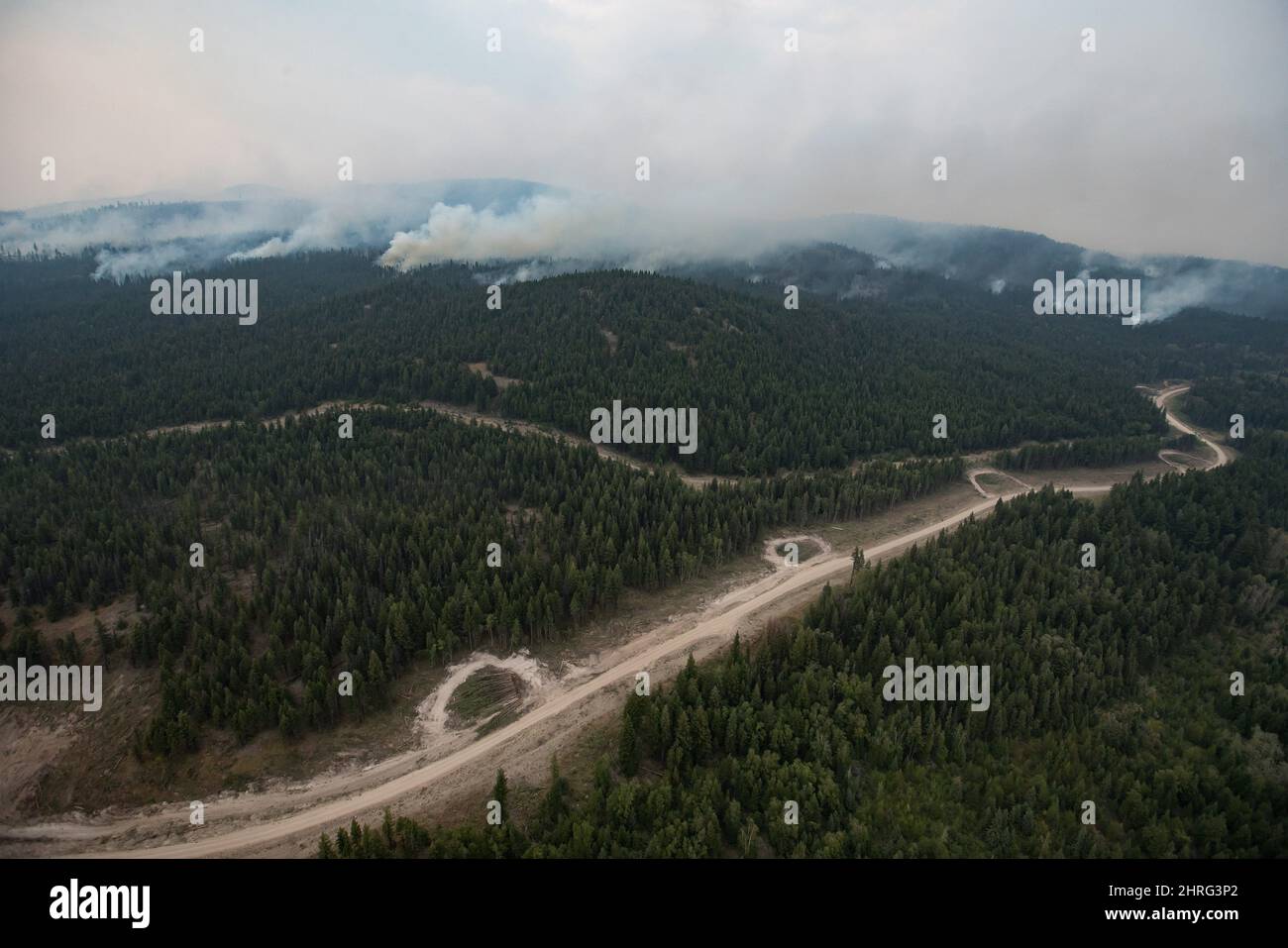 The Shovel Lake wildfire burns on a mountain above a fire break near ...