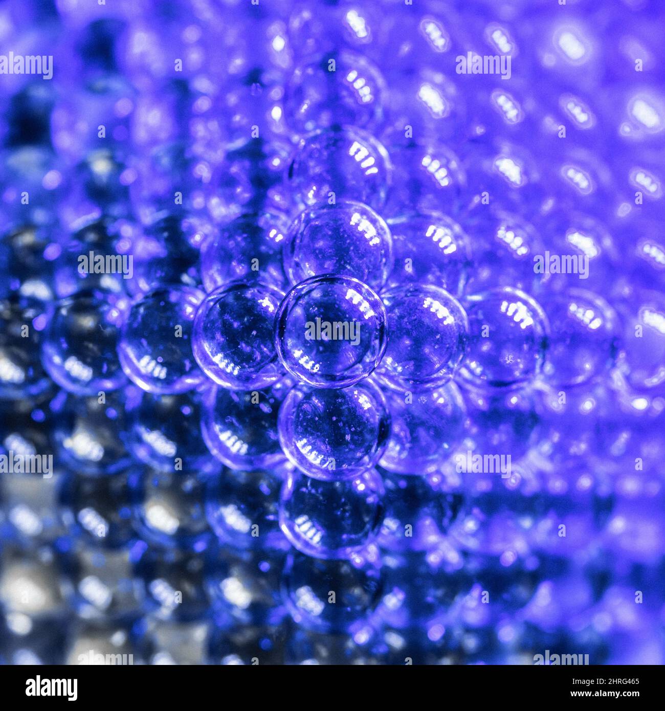 Macro shot of lit blue and grey marbles forming a pyramid Stock Photo ...