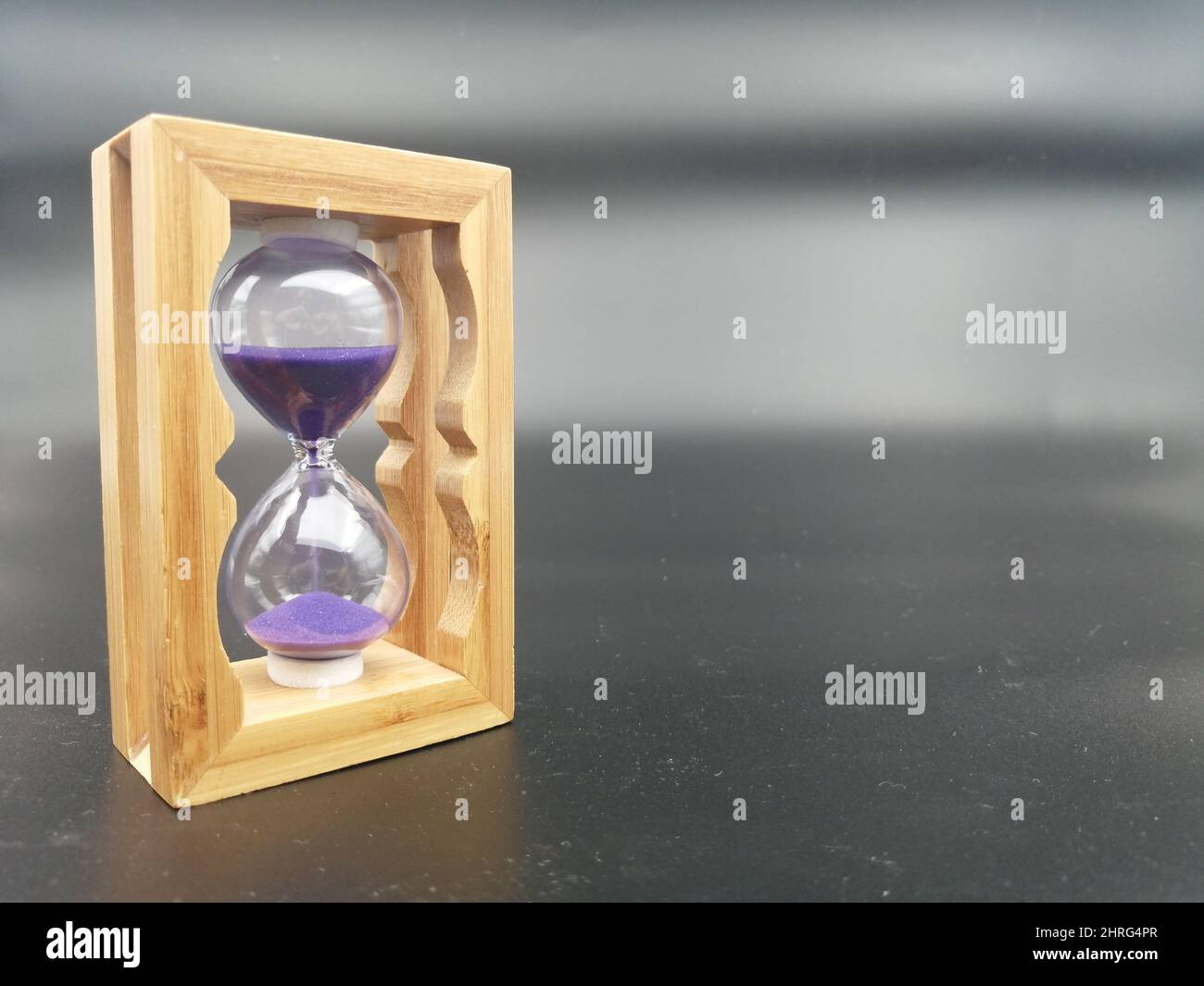 Close-up shot of the wooden sand clock with purple sand Stock Photo - Alamy