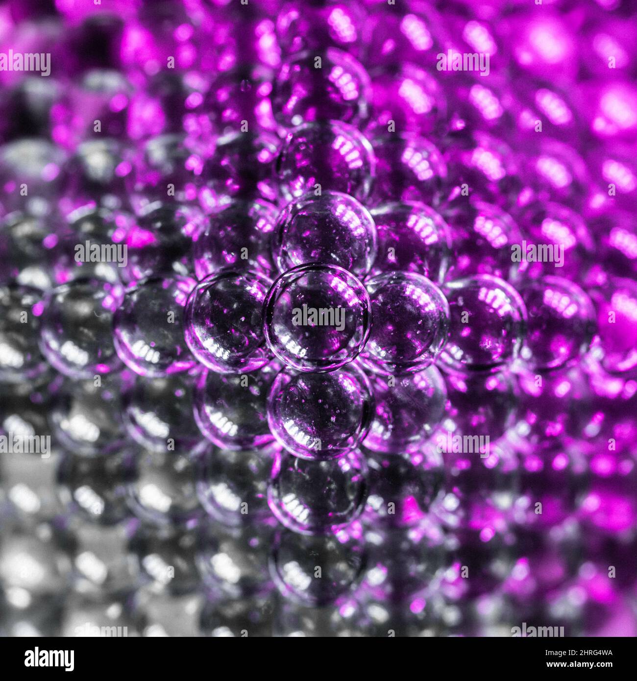 Macro shot of lit purple and grey marbles forming a pyramid Stock Photo ...