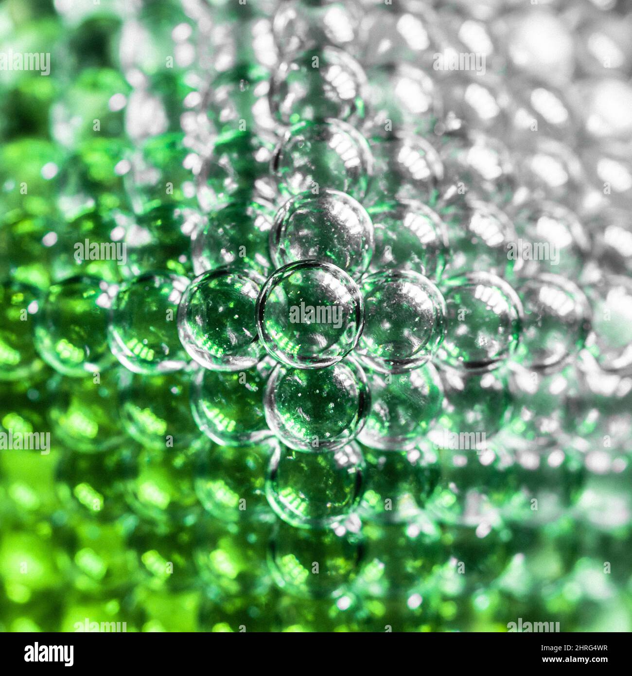 Macro shot of lit green and grey marbles forming a pyramid Stock Photo ...