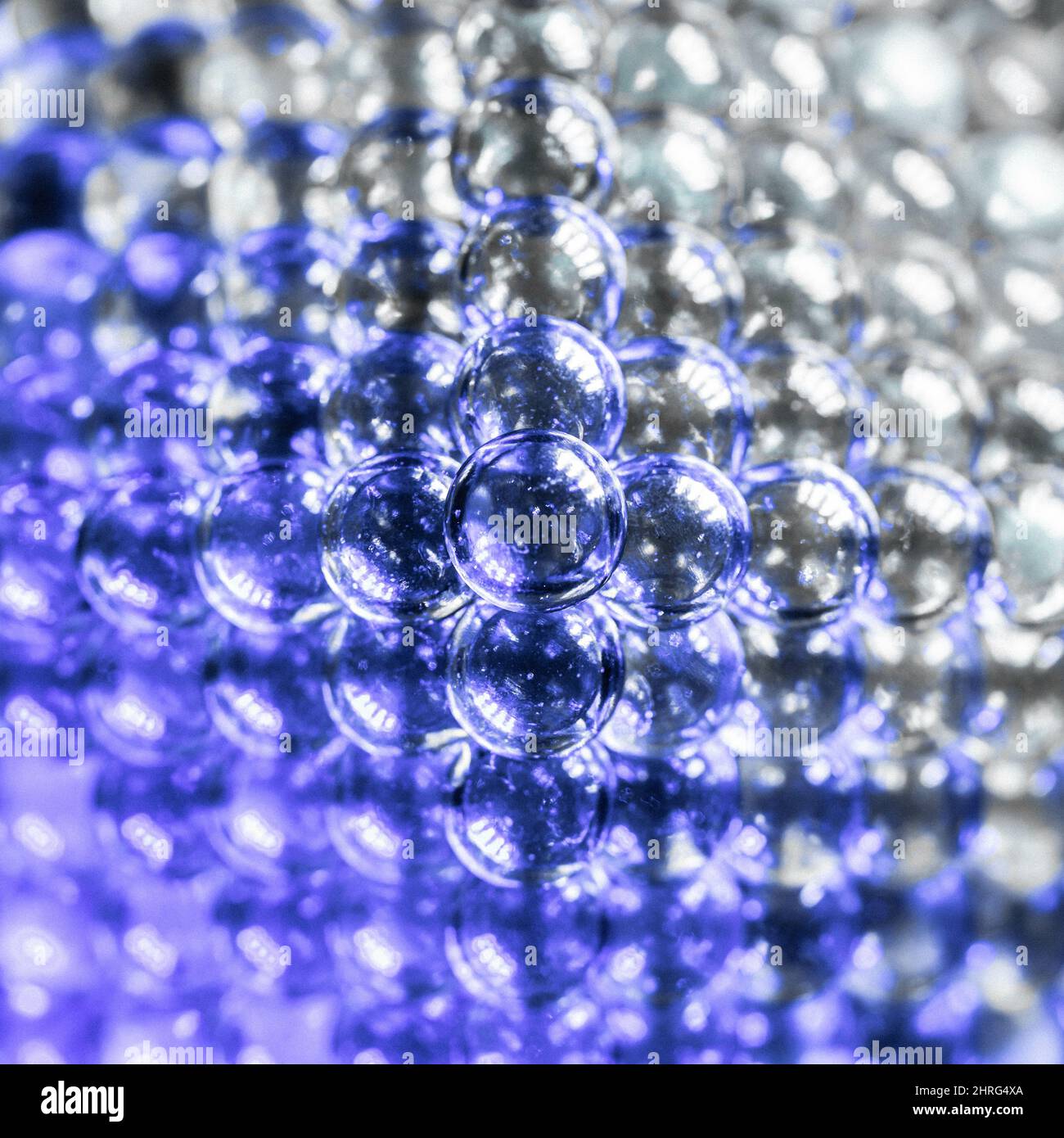 Macro shot of lit blue and grey marbles forming a pyramid Stock Photo ...