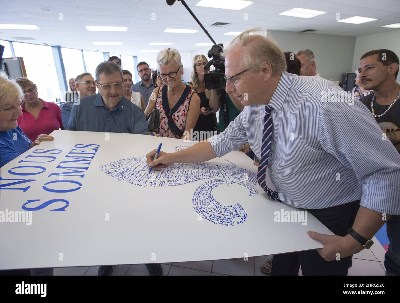 PQ Leader Jean-Francois Lisee signs a poster while campaigning at the ...