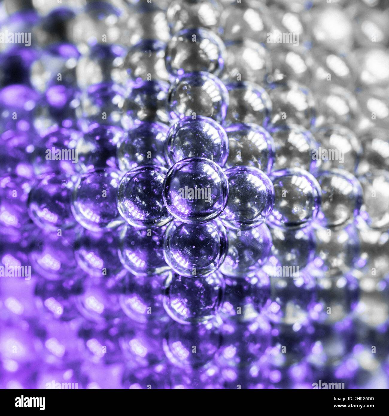 Macro shot of lit purple and grey marbles forming a pyramid Stock Photo ...