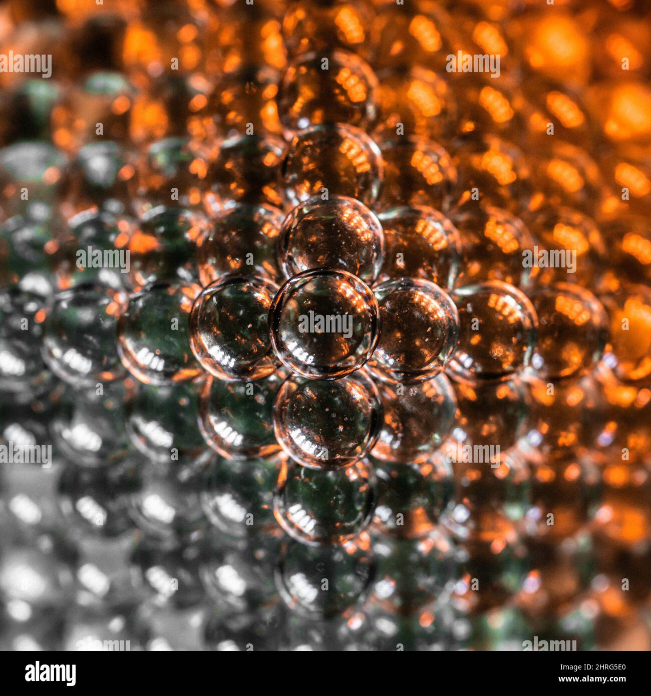 Macro shot of lit orange and grey marbles forming a pyramid Stock Photo ...