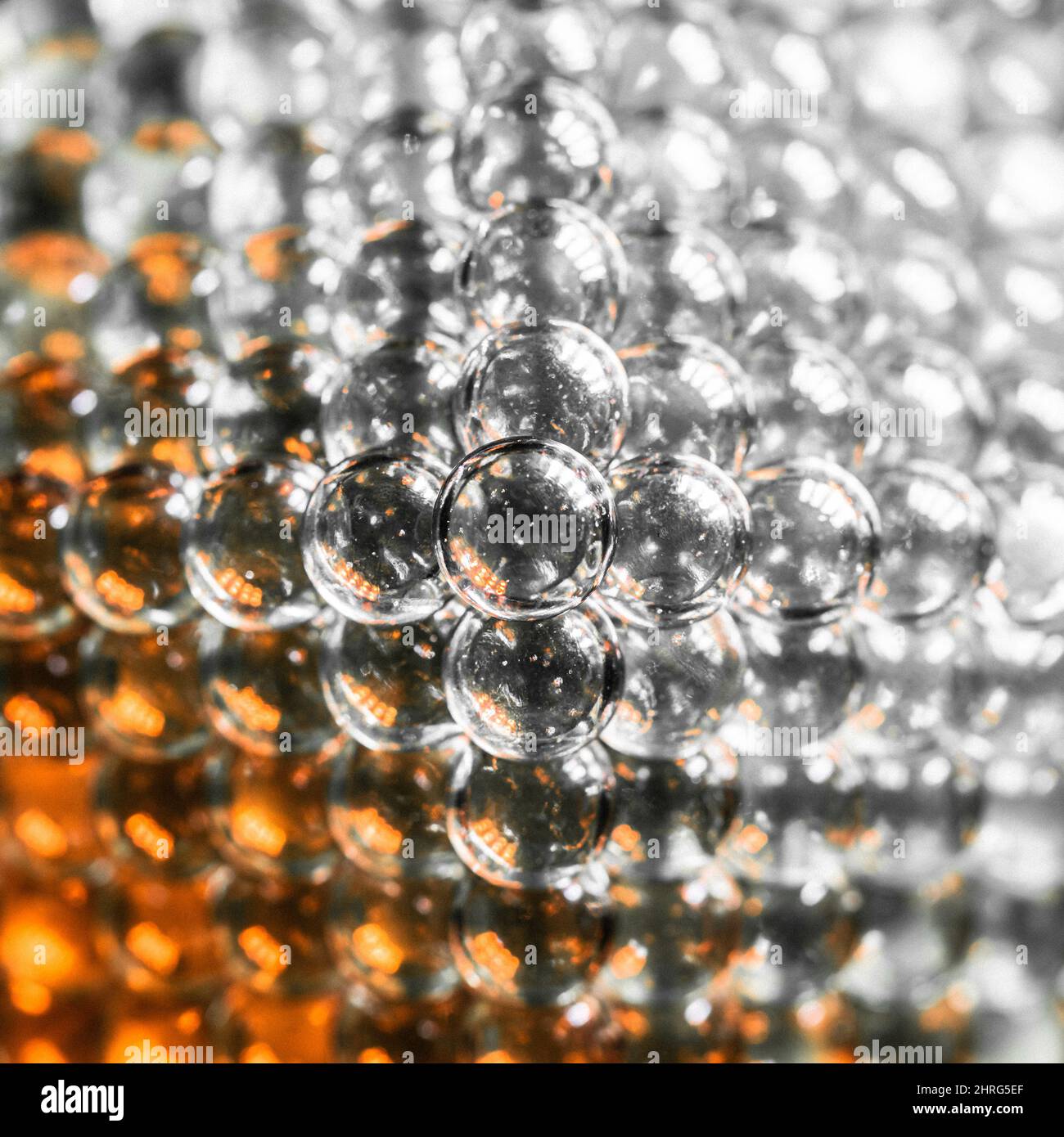 Macro shot of lit orange and grey marbles forming a pyramid Stock Photo ...