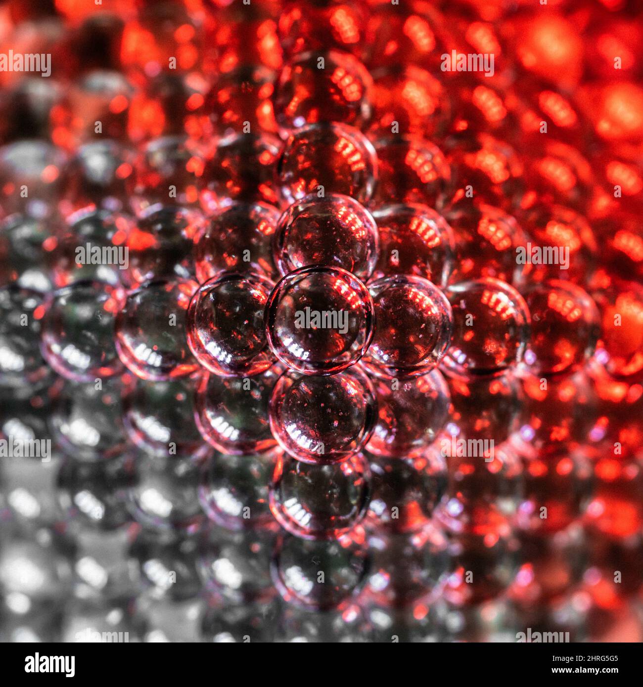 Macro shot of lit red and grey marbles forming a pyramid Stock Photo ...