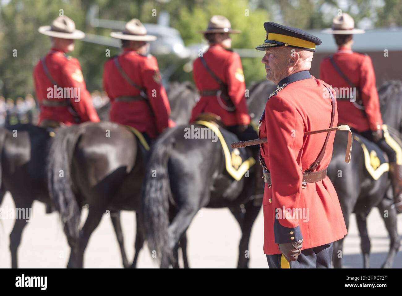 Outgoing RCMP Commissioner Bob Paulson, right, looks on while mounted ...