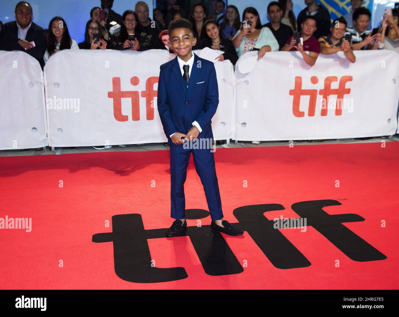 Actor TJ Wright poses for photographs on the red carpet after arriving ...