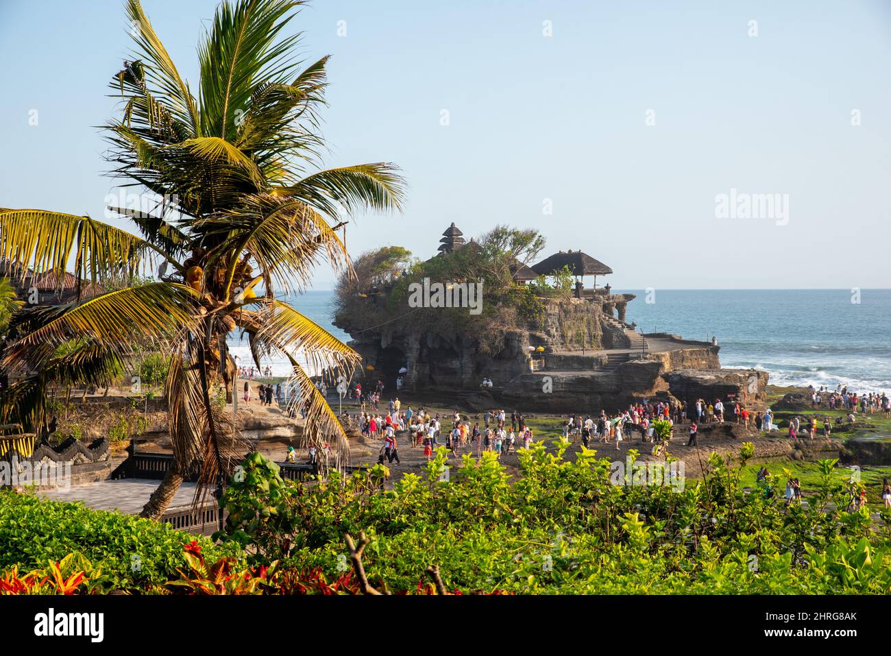 Famous Hindu temple facing the ocean in a small Tanah Lot islet in Bali ...