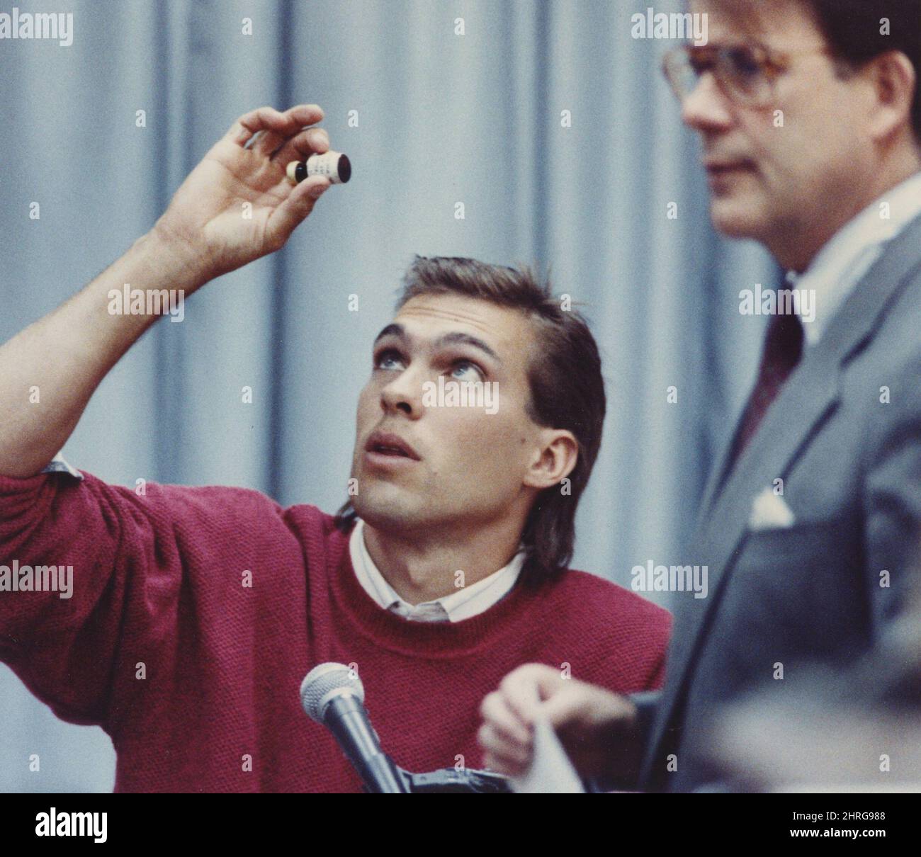 Decathlete Dave Steen looks at a bottle of evidence as commission ...