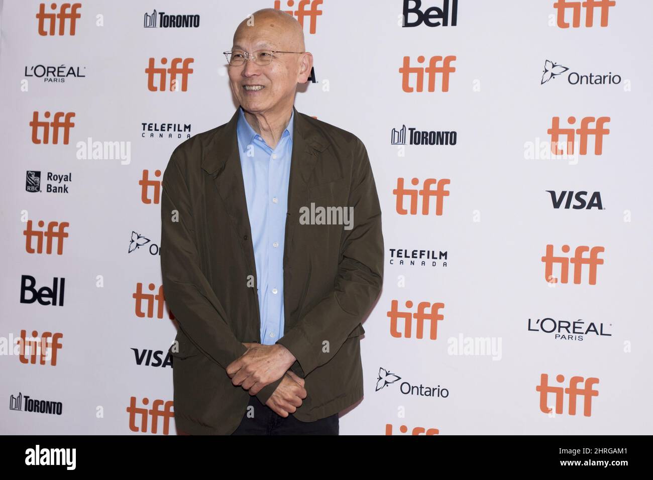 Director Wayne Wang poses for photos on the red carpet for the premiere ...