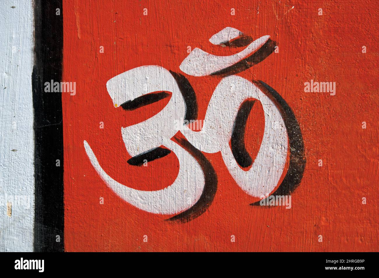 Close up shot of the Om symbol street art on the red background Stock ...
