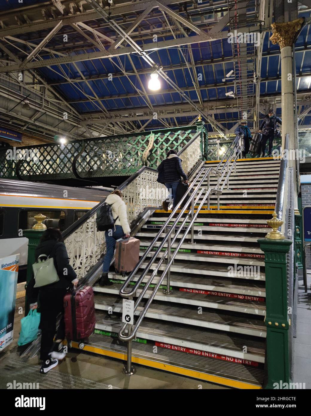 A view of people on stairs inside an urban modern train station of a ...