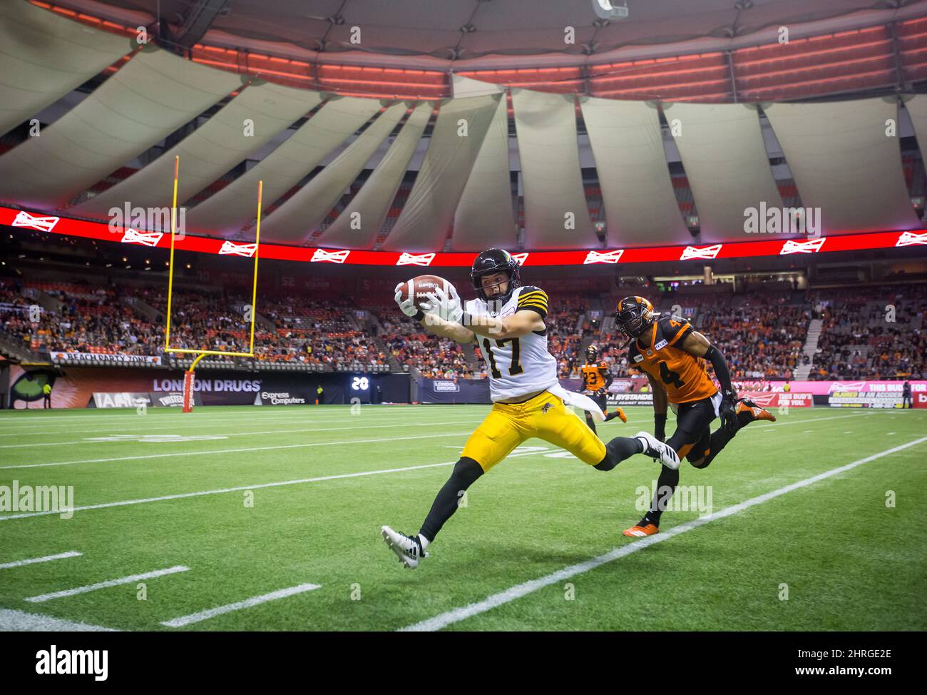 Hamilton Tiger-Cats' Luke Tasker (17) makes a reception in front of B.C ...