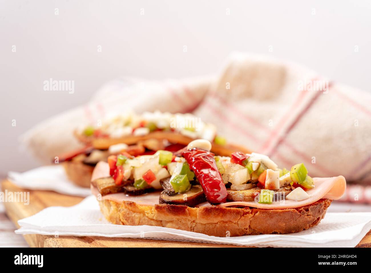 Typical Spanish tapas made with a brusqueta and different toppings on ...