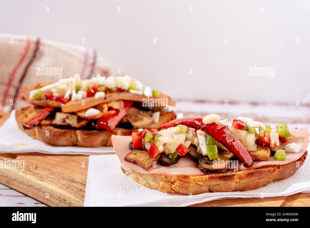 Typical Spanish tapas made with a brusqueta and different toppings on ...