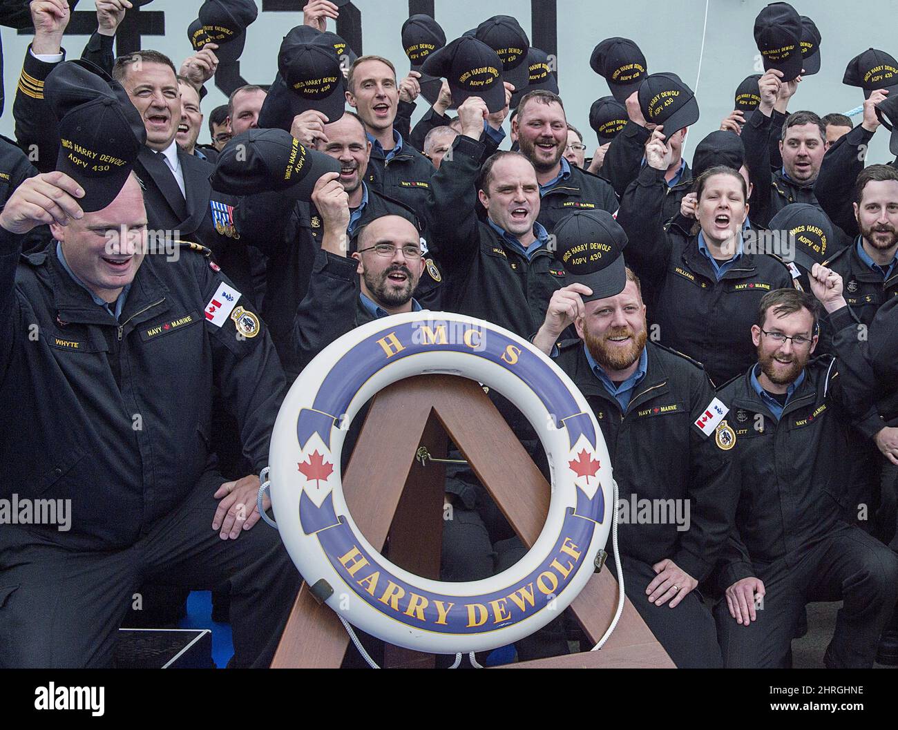 Crew members cheer at the end of the naming ceremony for Canada's lead ...
