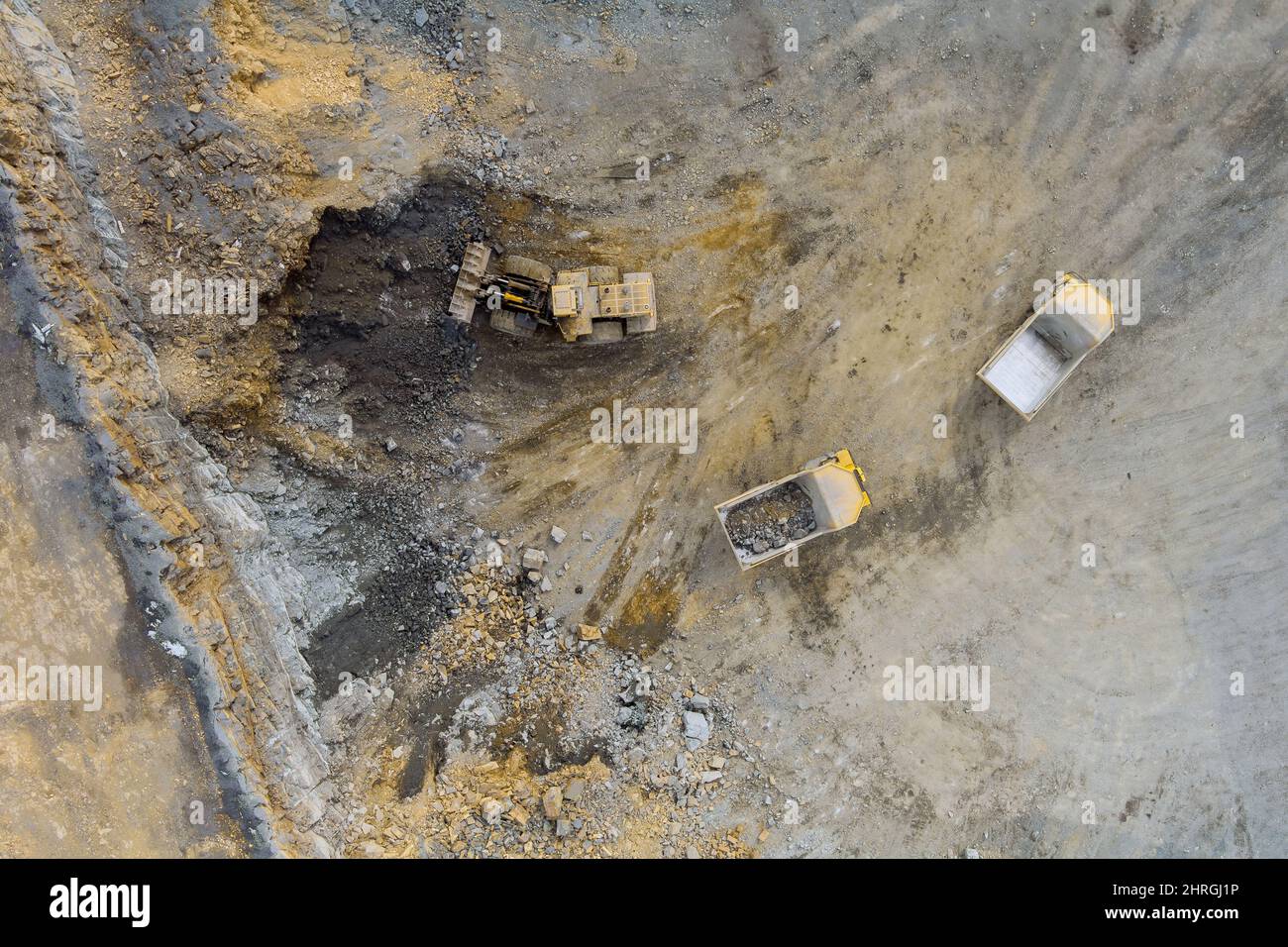 Heavy dump-body truck loaded with limestone ore moves along the road in ...