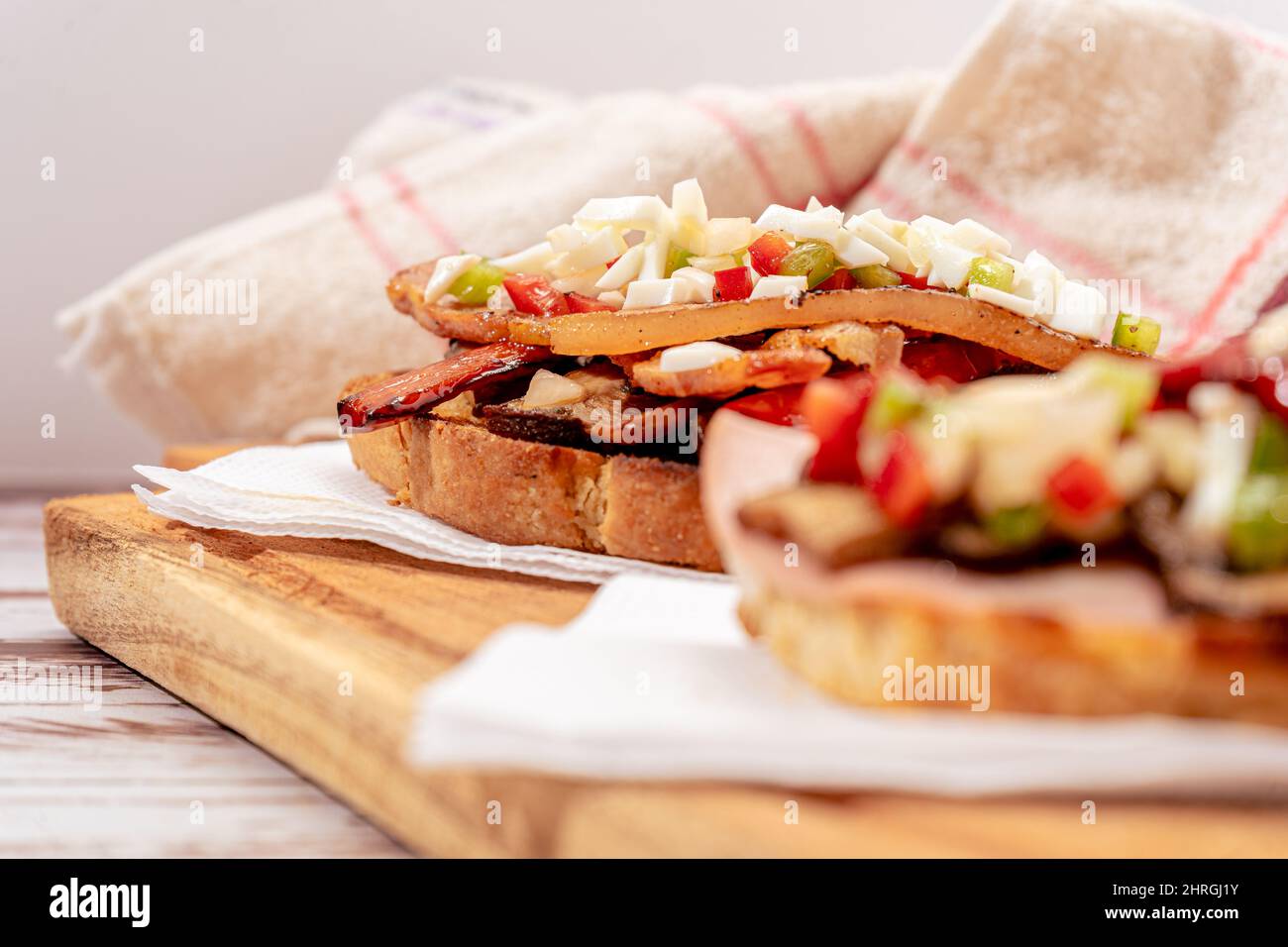 Typical Spanish tapas made with a brusqueta and different toppings on ...