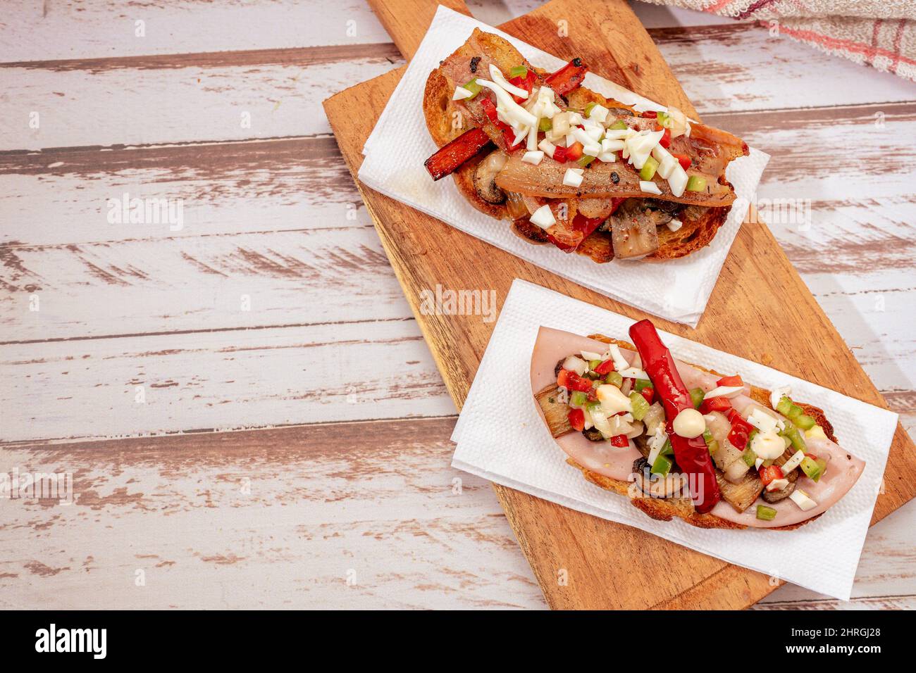 Typical Spanish tapas made with a brusqueta and different toppings on ...