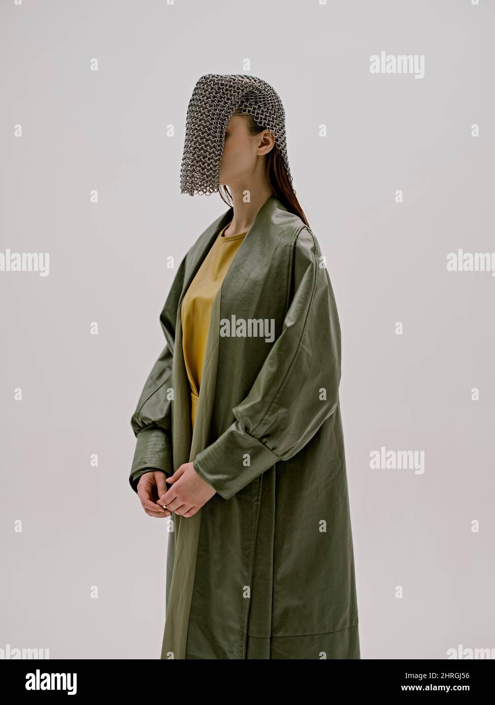 young woman chain mail on the face leather green coat luxury light ...