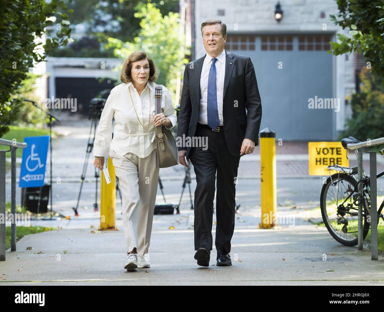 Toronto Mayor John Tory accompanies his mother Elizabeth Bacon to vote ...