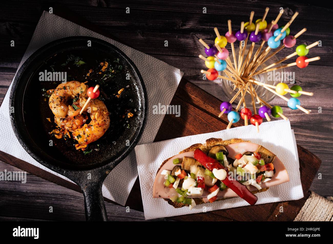 Two different typical Spanish tapas on a rustic table with a dark ...