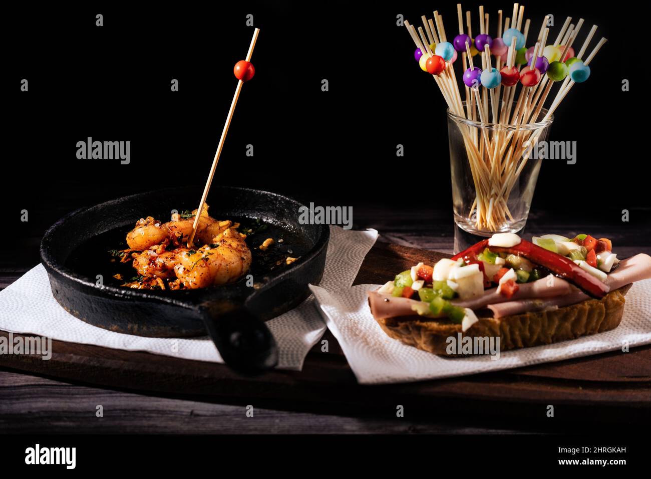 Two different typical Spanish tapas on a rustic table with a dark ...