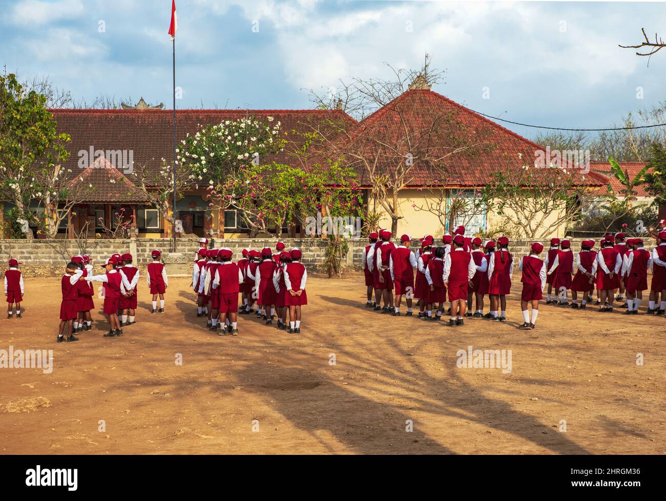 Group of School children wearing beautiful red uniforms lined up in the ...