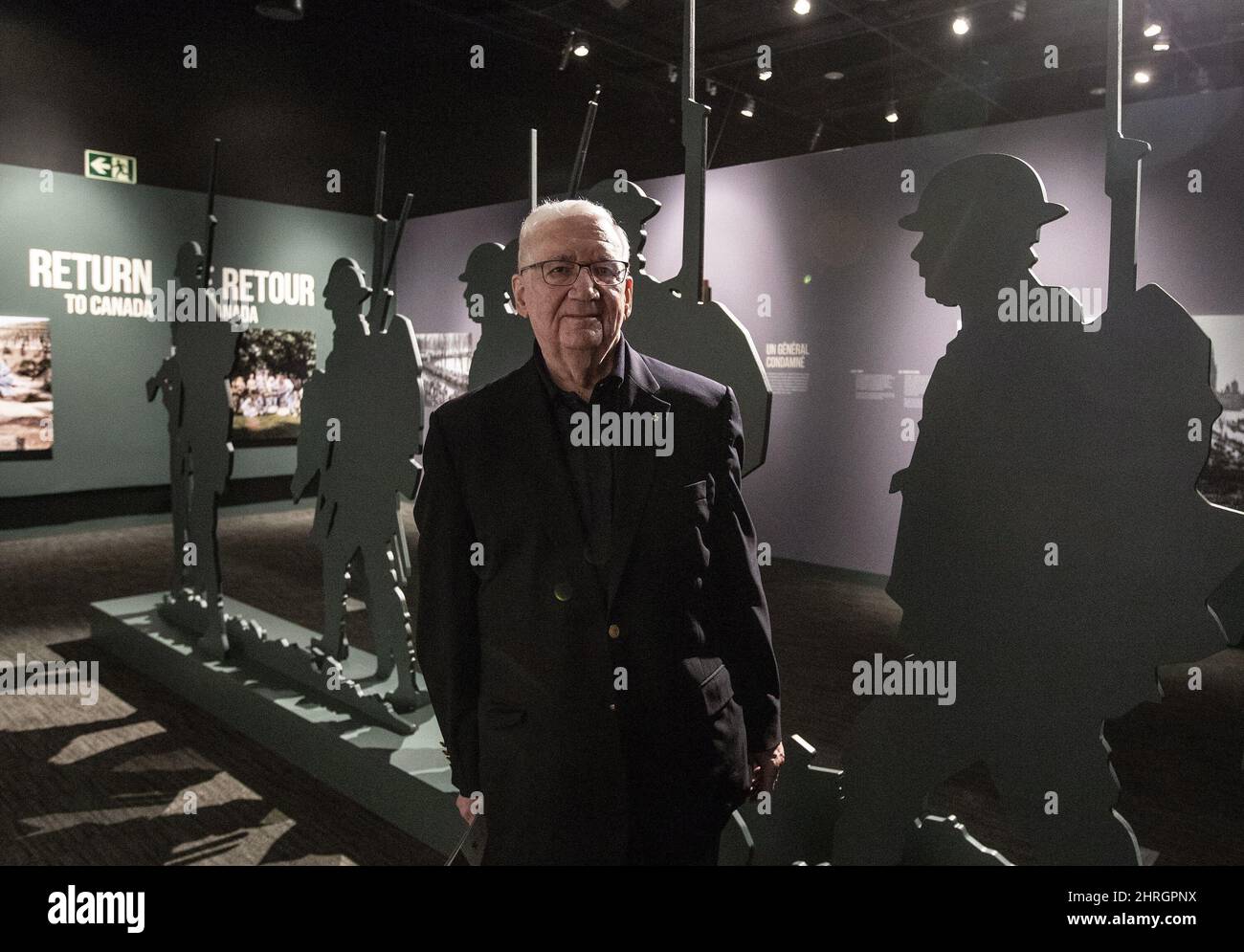Military historian and curatorJack Granatstein stands beside wooden ...