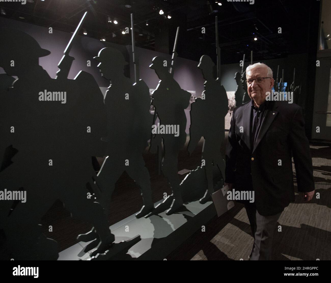 Military historian and curatorJack Granatstein stands beside wooden ...