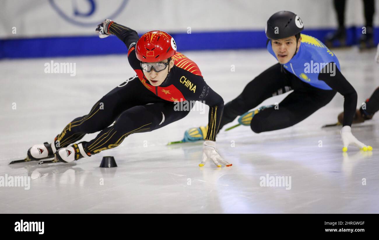 China's Wu Dajing, left, skates to victory in front of Kazakhstan's ...