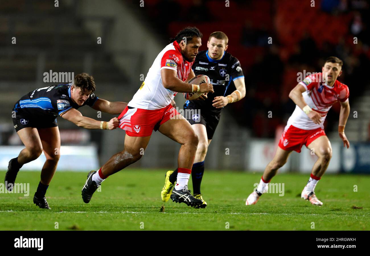 St Helens' Agnatius Paasi (centre) is pulled back by Wakefield Trinity ...