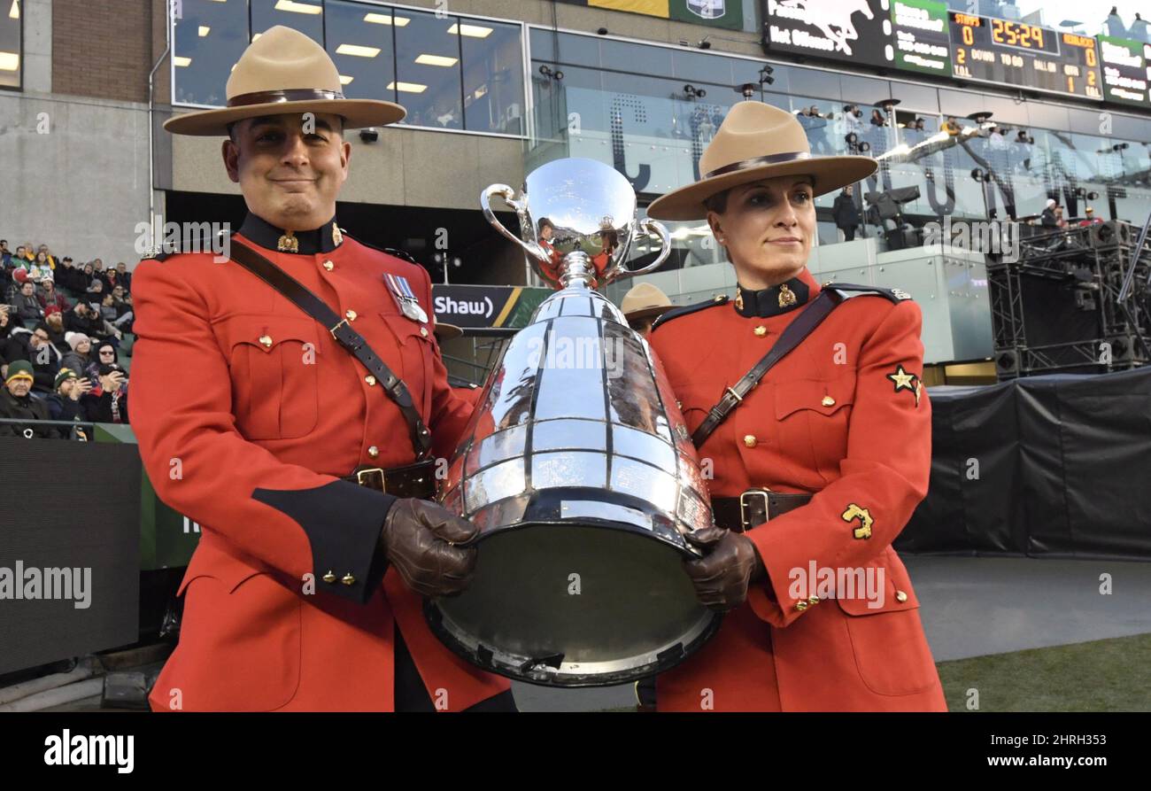 Members of the RCMP carry in the Grey Cup trophy at the beginning of ...