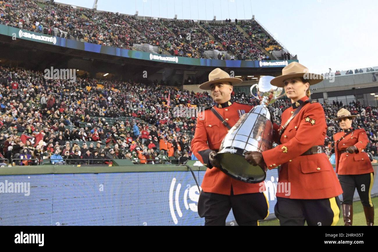 Members of the RCMP carry in the Grey Cup trophy at the beginning of ...