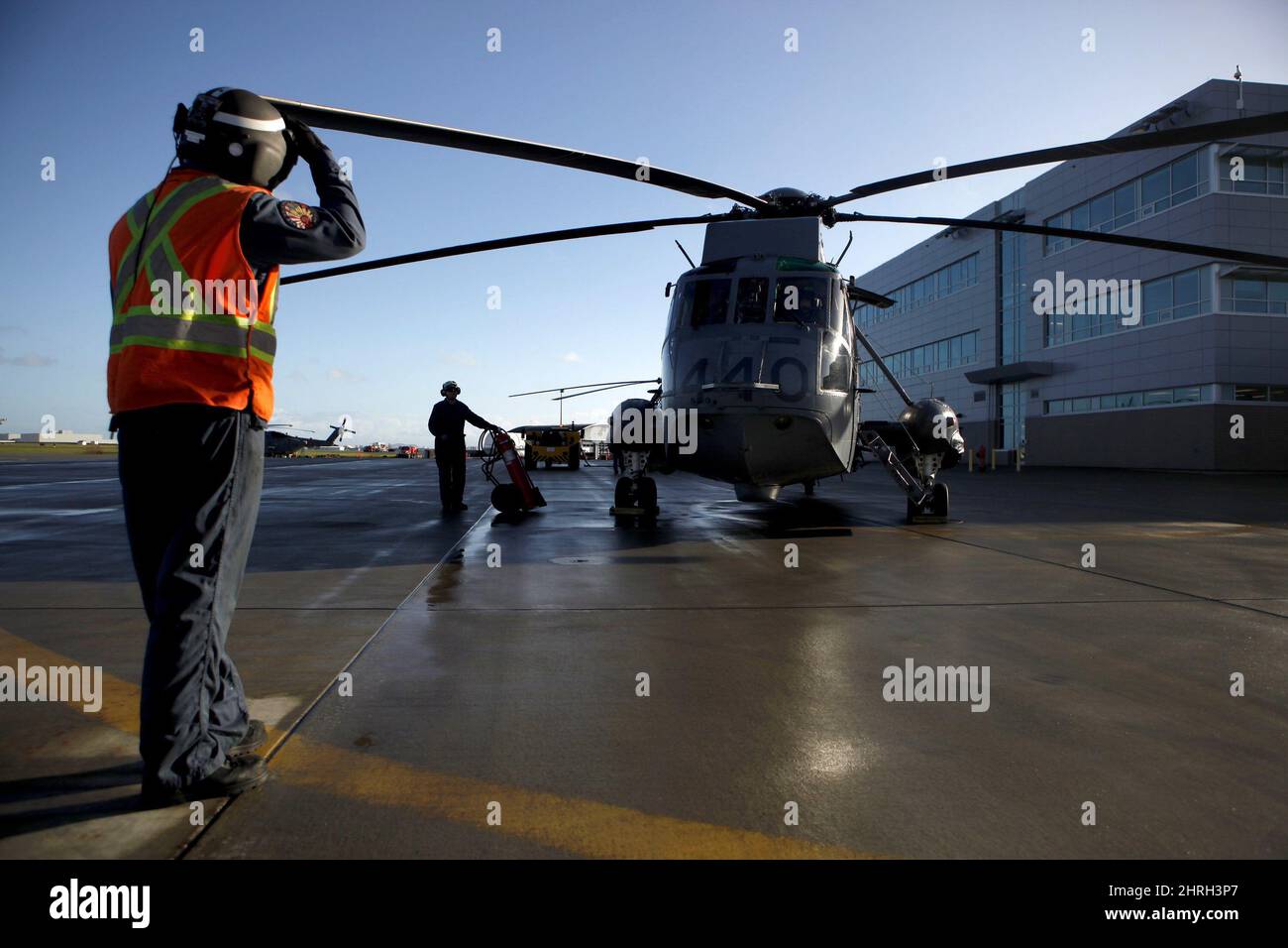 A crew readies the CH-124 Sea King helicopter before takeoff at 443 ...