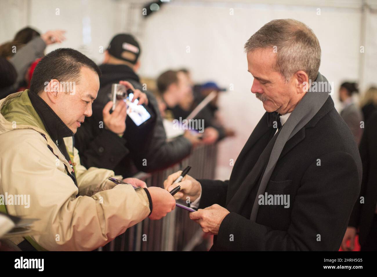Chris Hadfield signs an autograph on the red carpet as he Is inducted ...