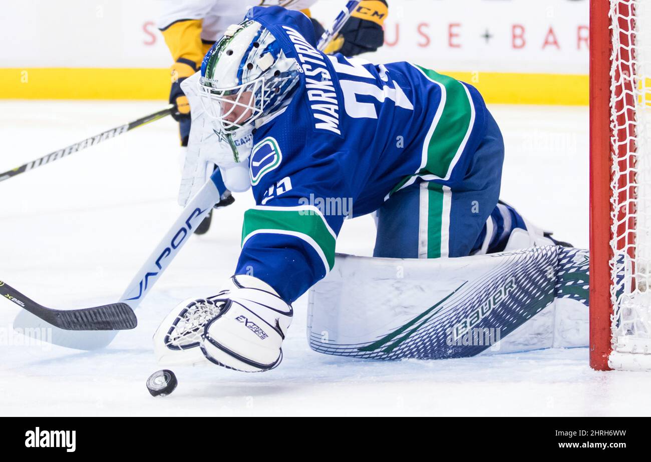 Vancouver Canucks goalie Jacob Markstrom, of Sweden, covers up the puck ...