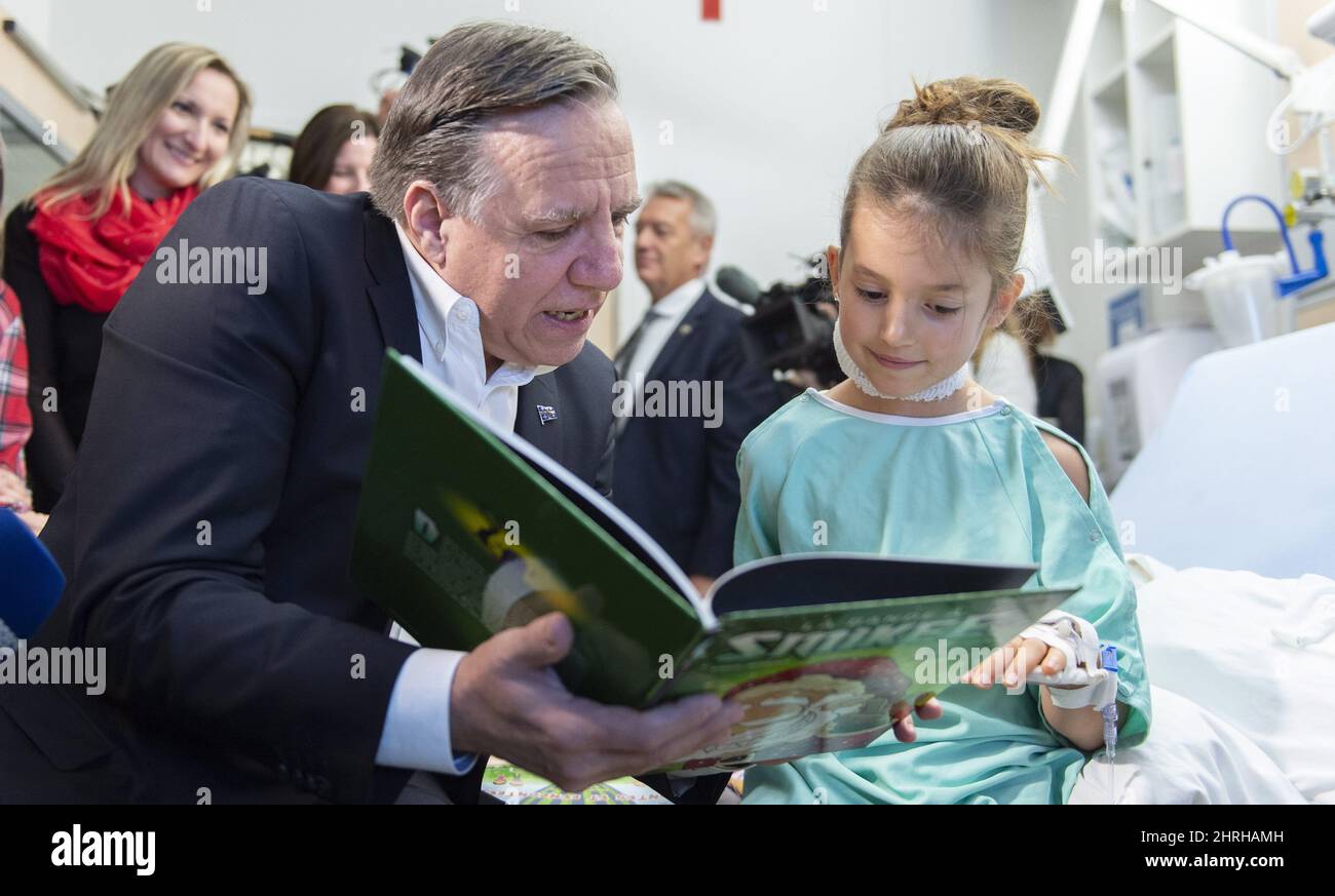 Quebec Premier Francois Legault reads a book with young Sara De ...