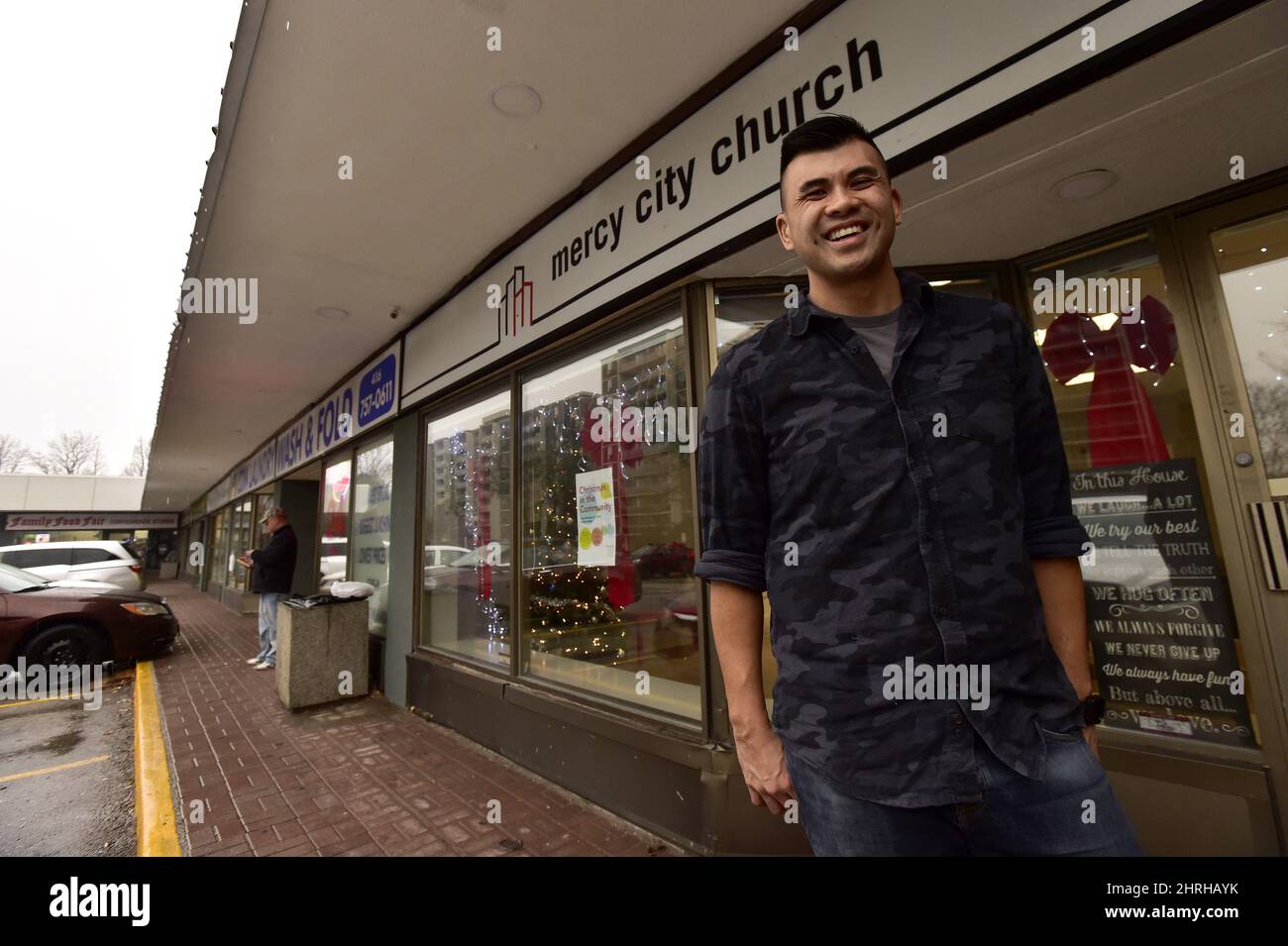 Pastor Chris Yu stands in front of the Mercy City Church in a strip ...
