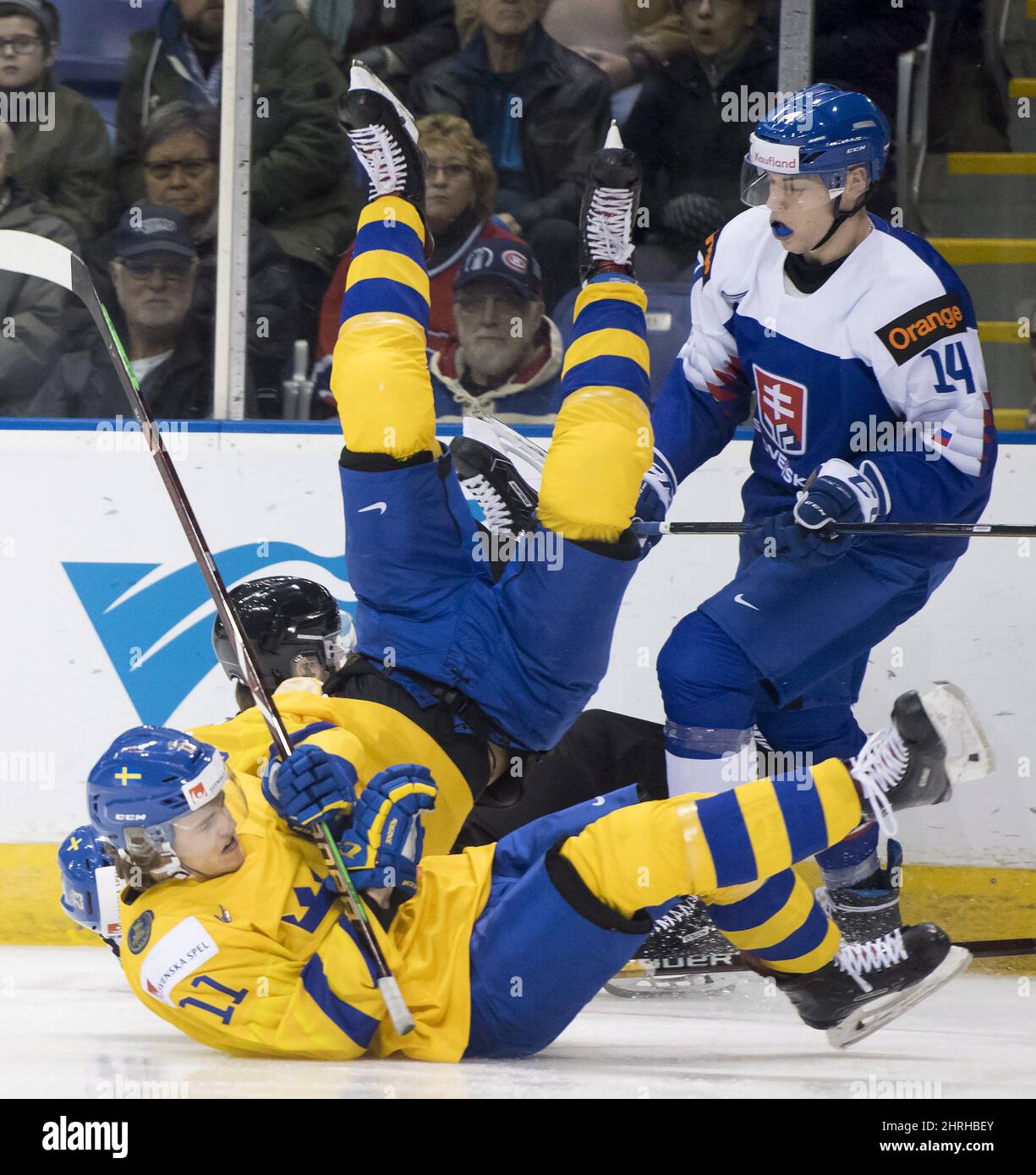 Sweden's Lucas Elvenes (23) flies over Sweden's Samuel Fagemo (11) as ...