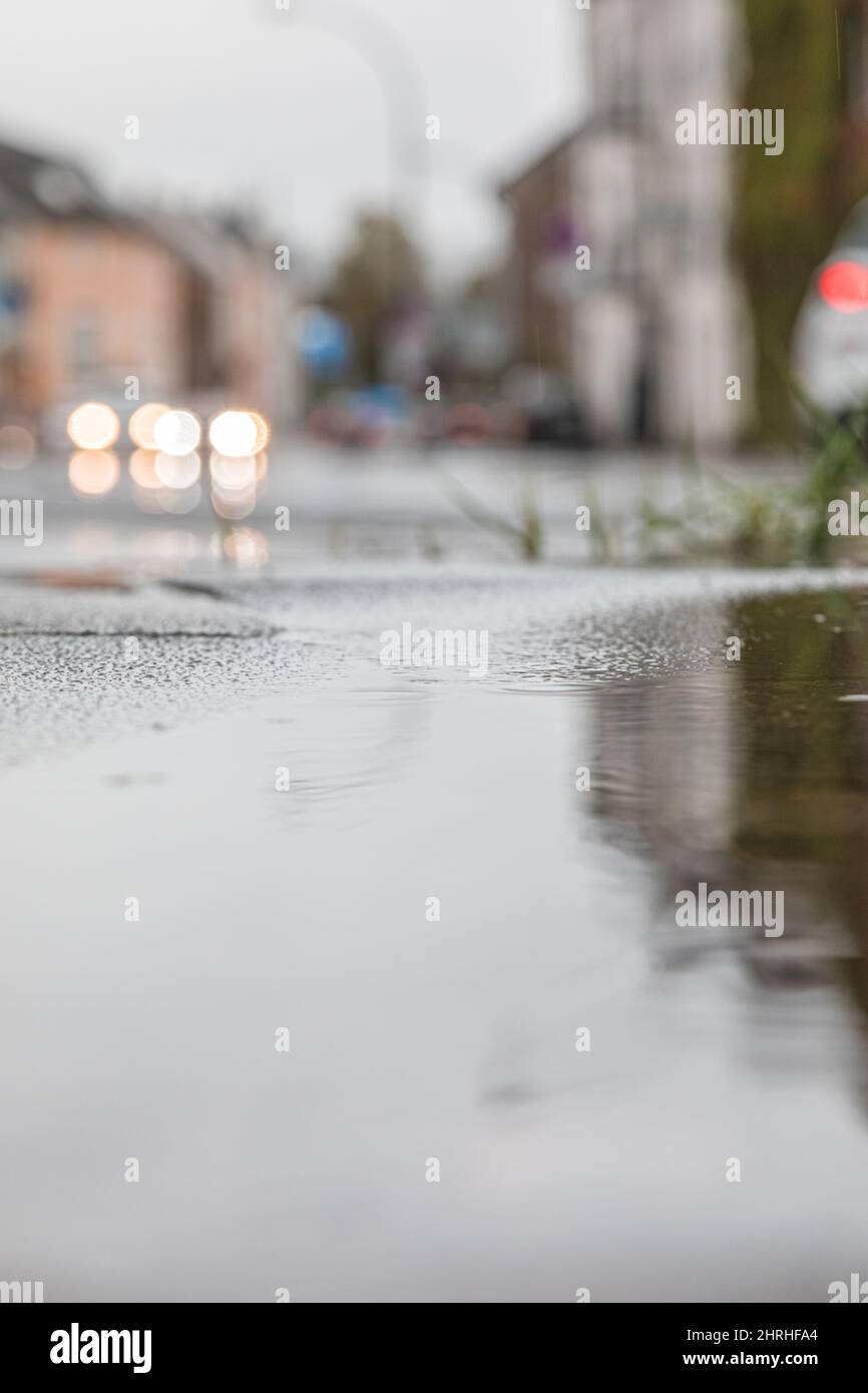 Vertical shot of the rainwater on the ground in a street Stock Photo ...
