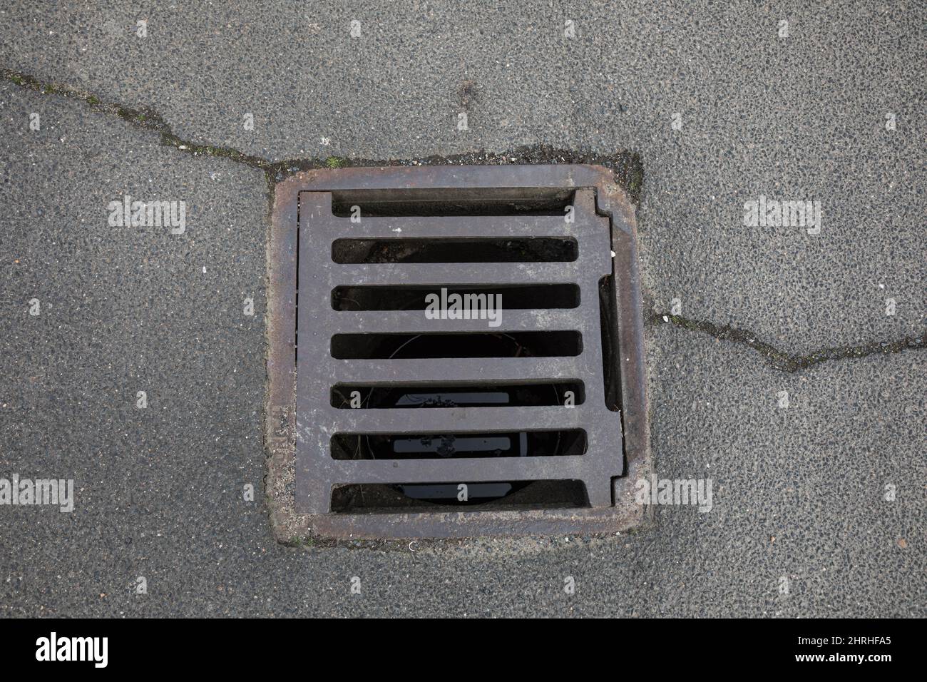 Metal grid for drainage of water on the ground Stock Photo - Alamy
